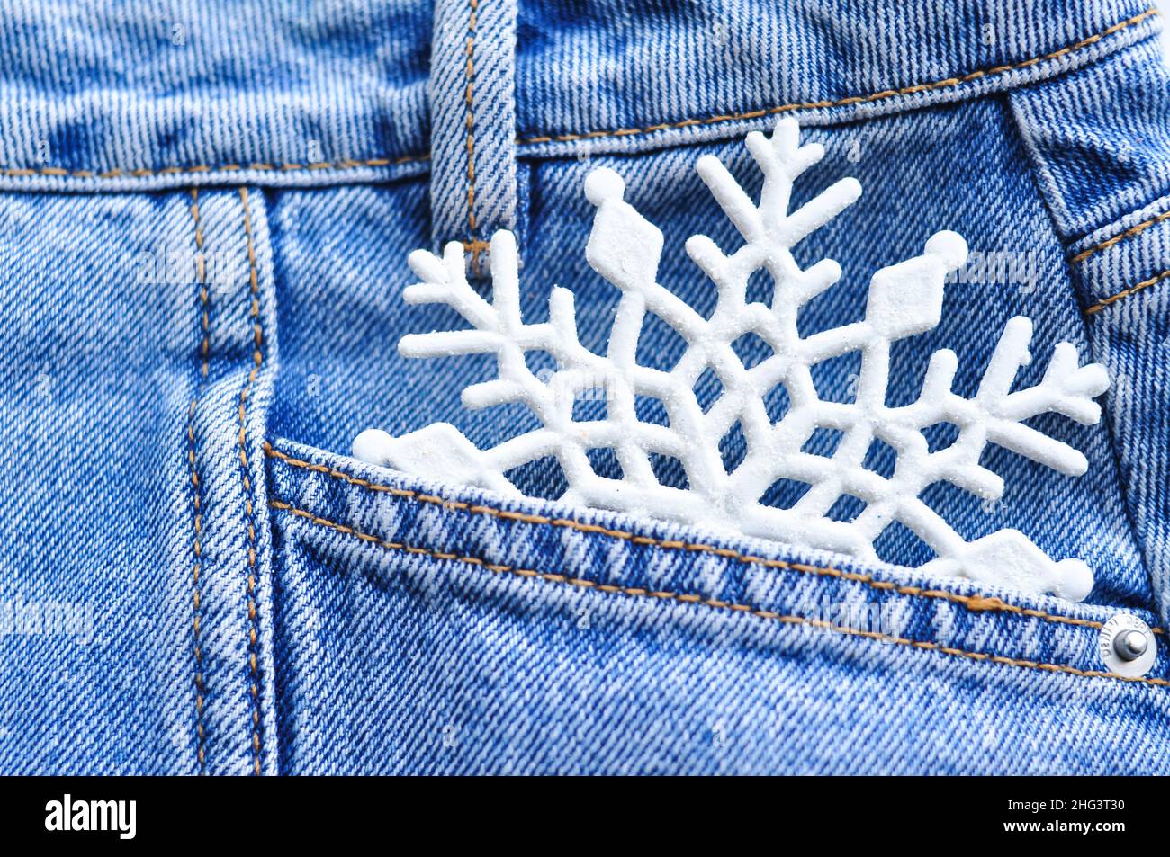 White snowflake in blue jeans pocket . High quality photo Stock Photo ...