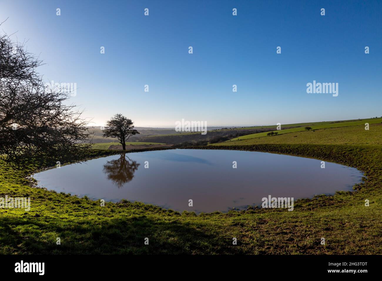 A dew pond on Ditchling Beacon on a sunny winters day Stock Photo - Alamy