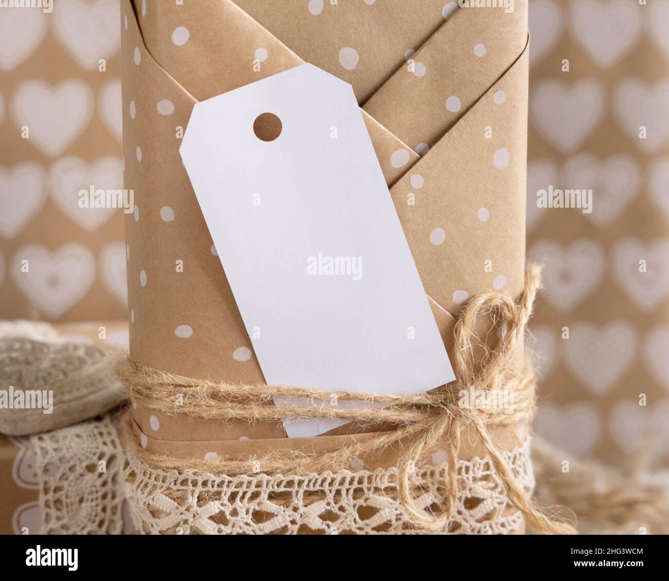 Valentines kraft paper wrapped present with vertical gift tag and ...