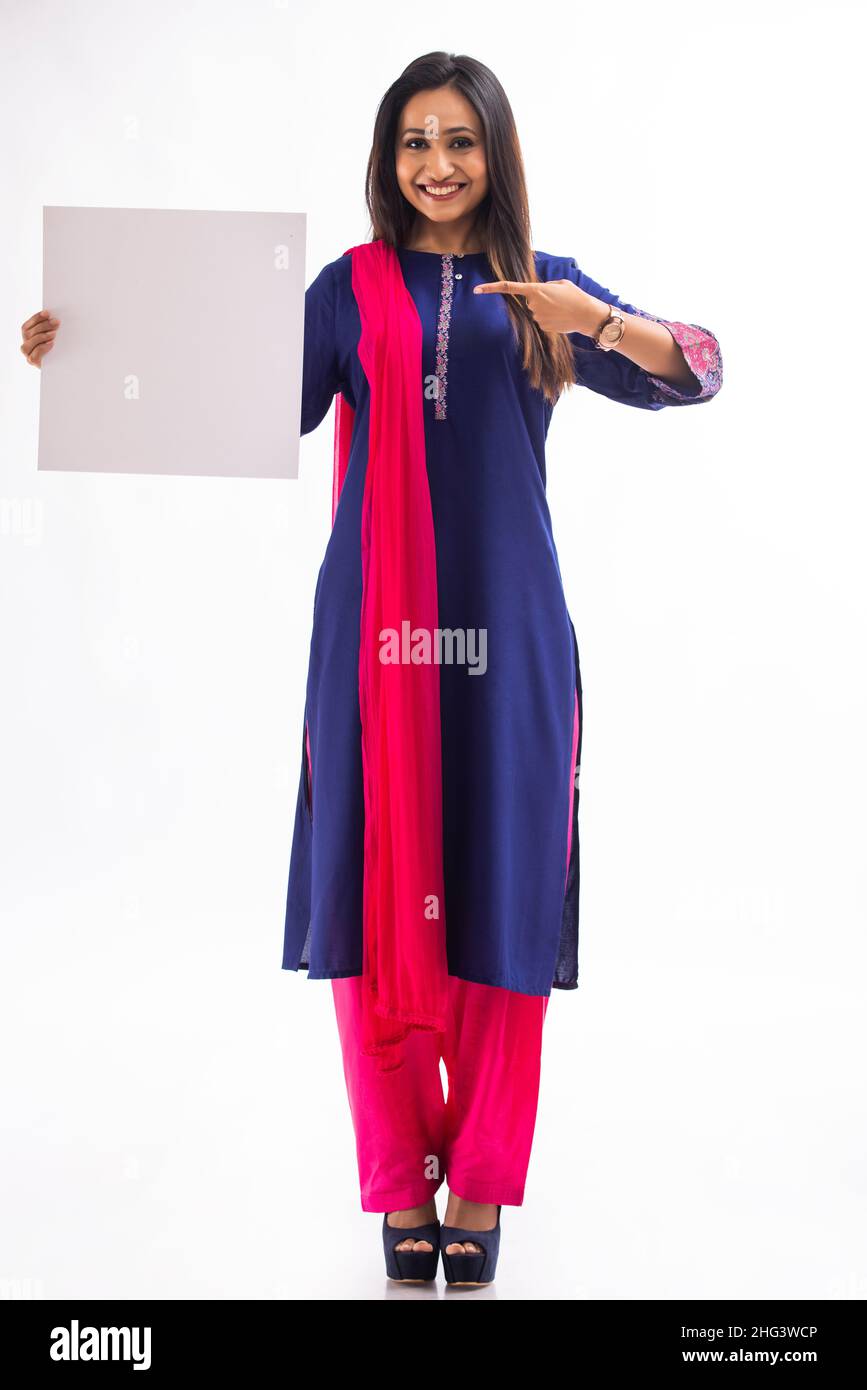 Young smiling woman holding a blank sheet of paper for advertising ...