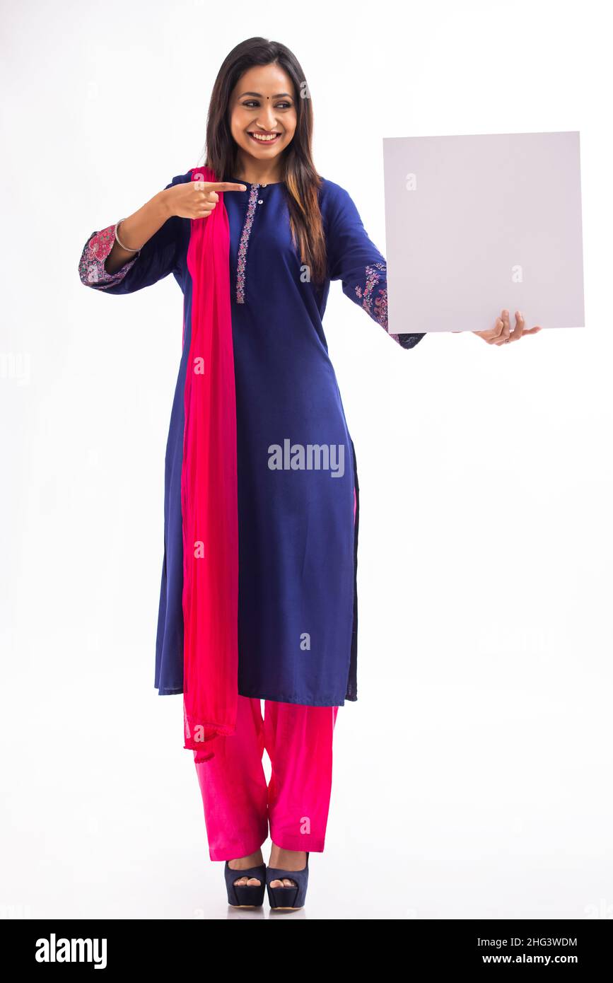 Young smiling woman holding a blank sheet of paper for advertising ...