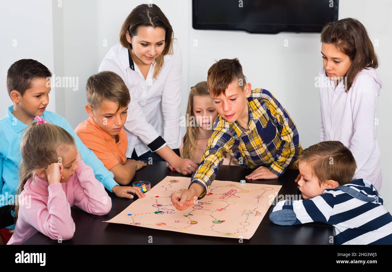 Boys and little girls playing at board game Stock Photo - Alamy