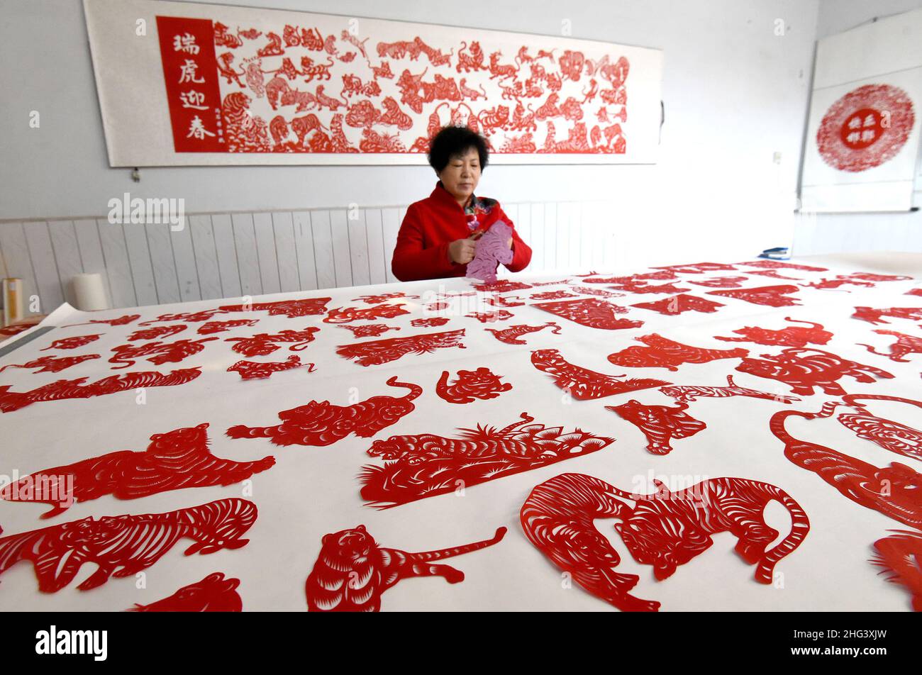 HANDAN, CHINA - JANUARY 18, 2022 - A folk paper cutting artist creates ...