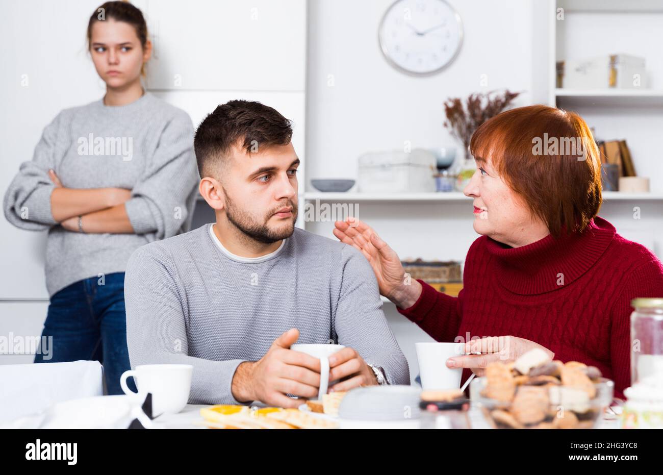 Woman calming upset guy during quarrel with girlfriend Stock Photo - Alamy