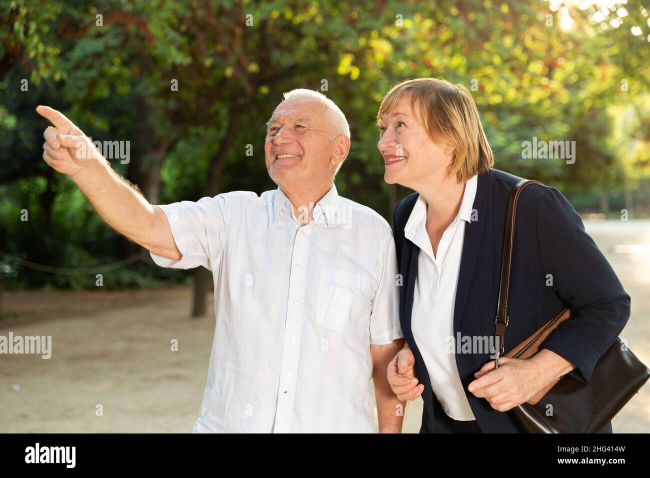 Elderly man pointing finger up Stock Photo - Alamy