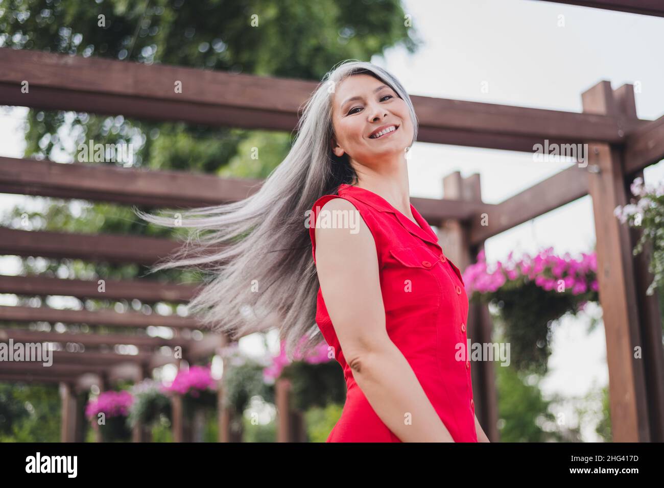 Portrait of attractive careless cheerful grey-haired woman spending day ...