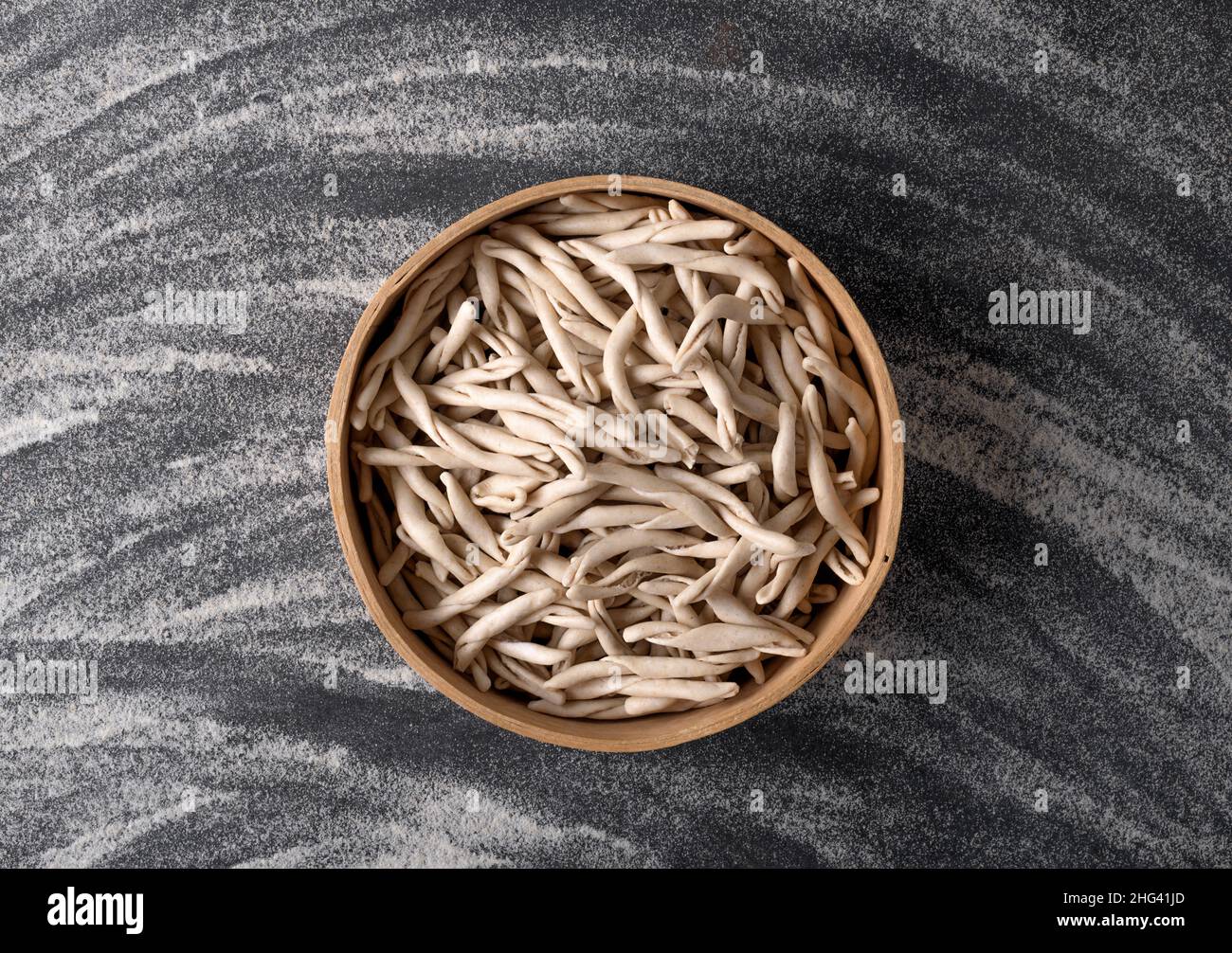 Whole grain wheat apulian pasta called Pizzarieddi or maccaruni in a ...