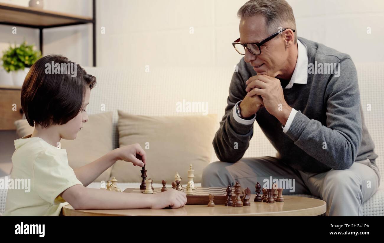 Grandpa playing chess board game hi-res stock photography and images ...