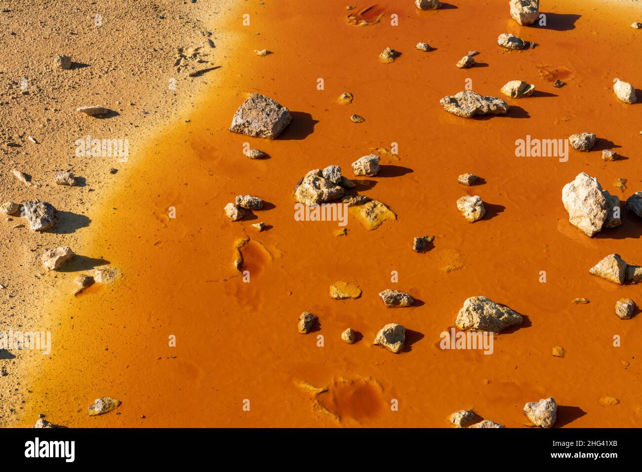 An abstract detail of a dried pond of polluted run-off water in an ...