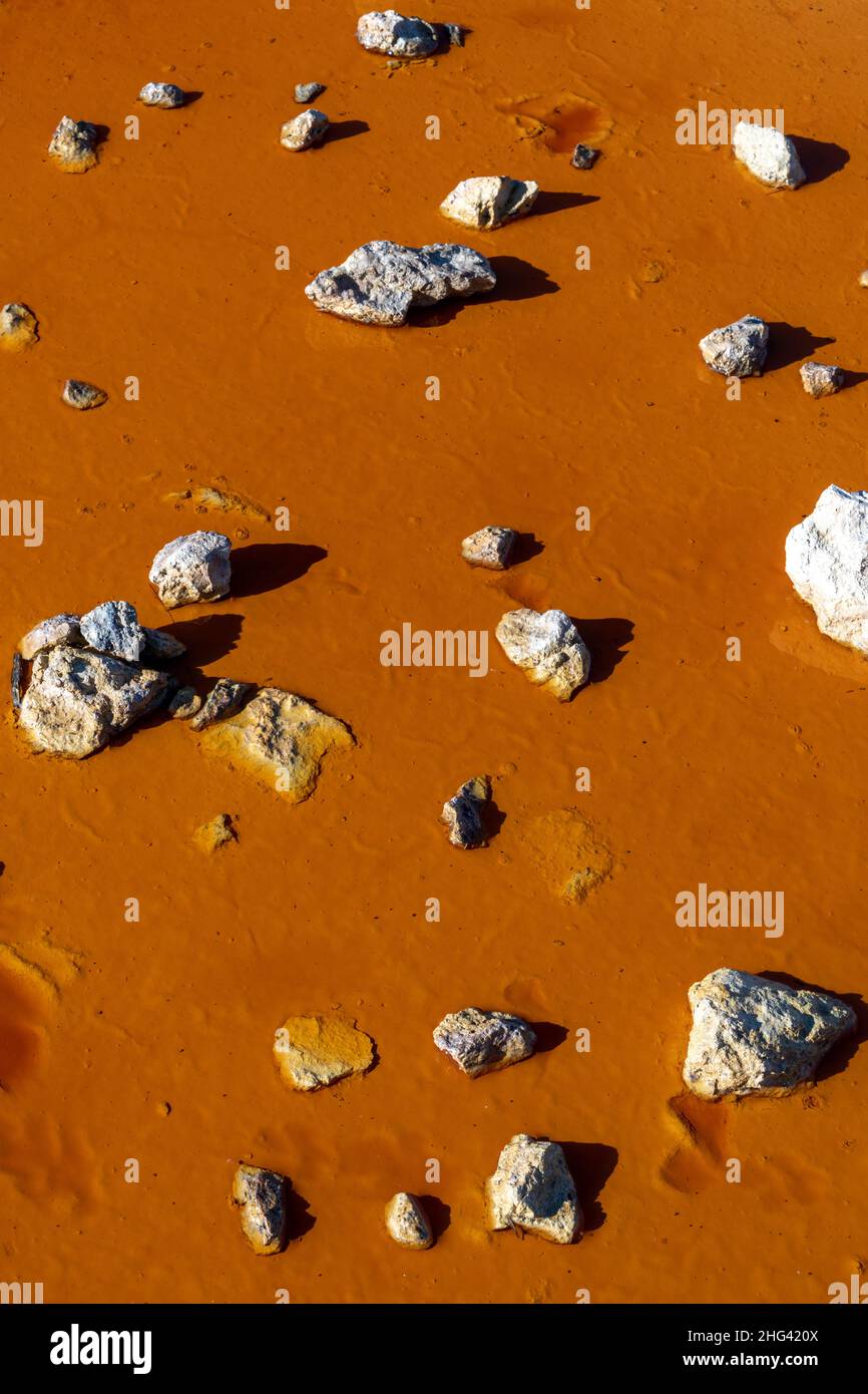 An abstract detail of a dried pond of polluted run-off water in an ...