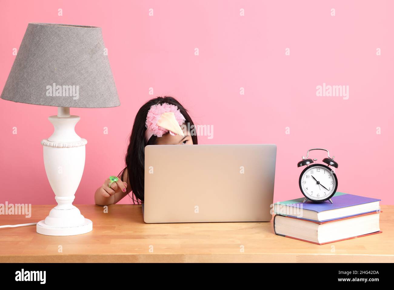 The cute Asian girl learning from internet by laptop with the pink ...