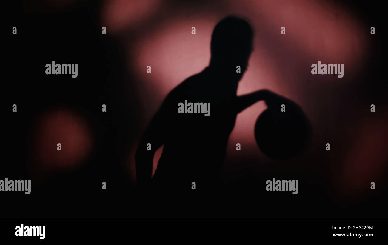 shadow of sportsman playing basketball on dark background Stock Photo ...