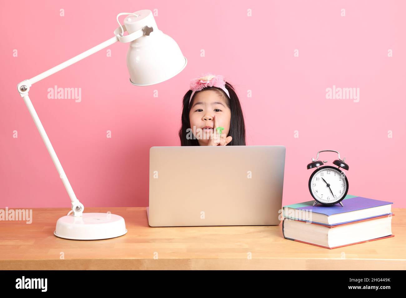 The cute Asian girl learning from internet by laptop with the pink ...