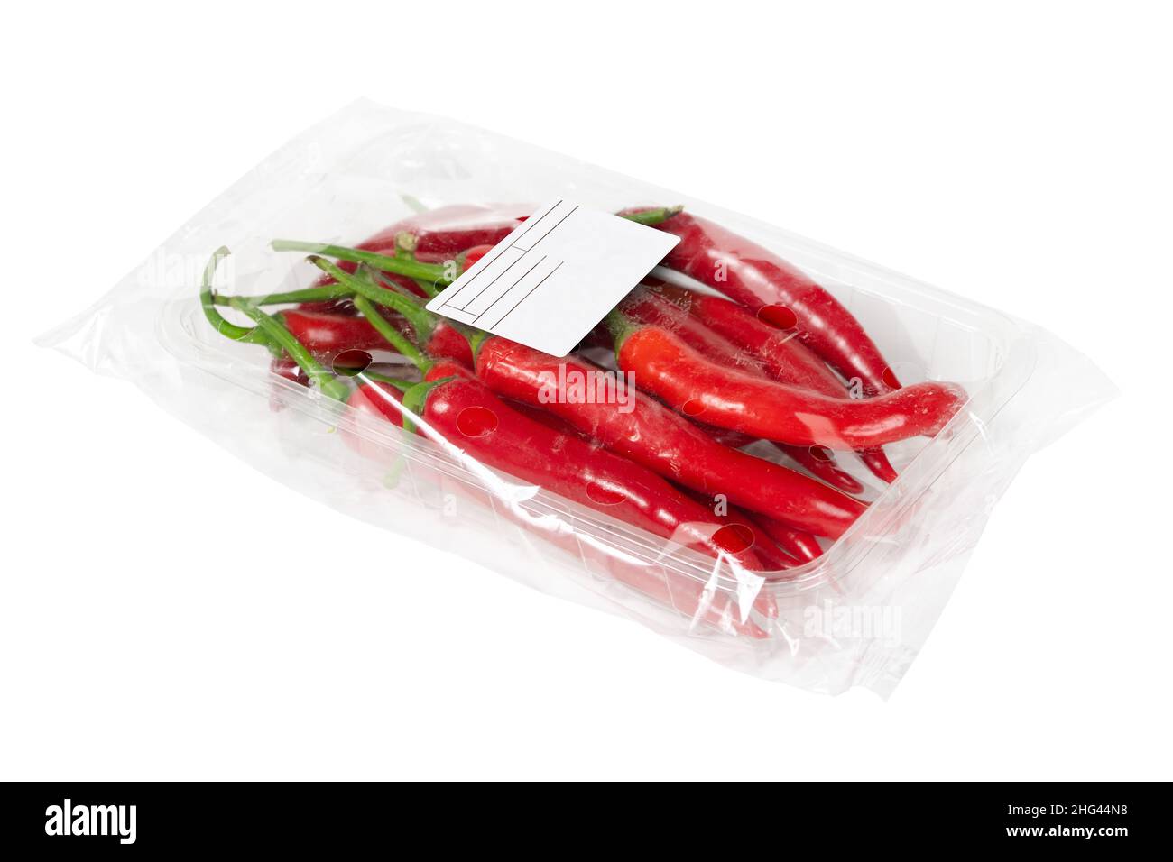 Packaged and labeled red chili peppers on an isolated white background ...