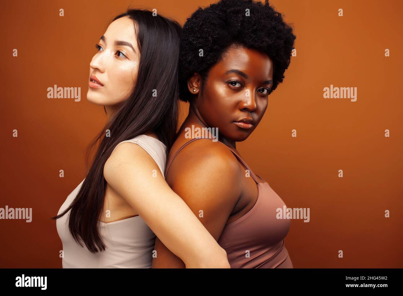 young pretty asian, african american woman posing cheerful together on ...