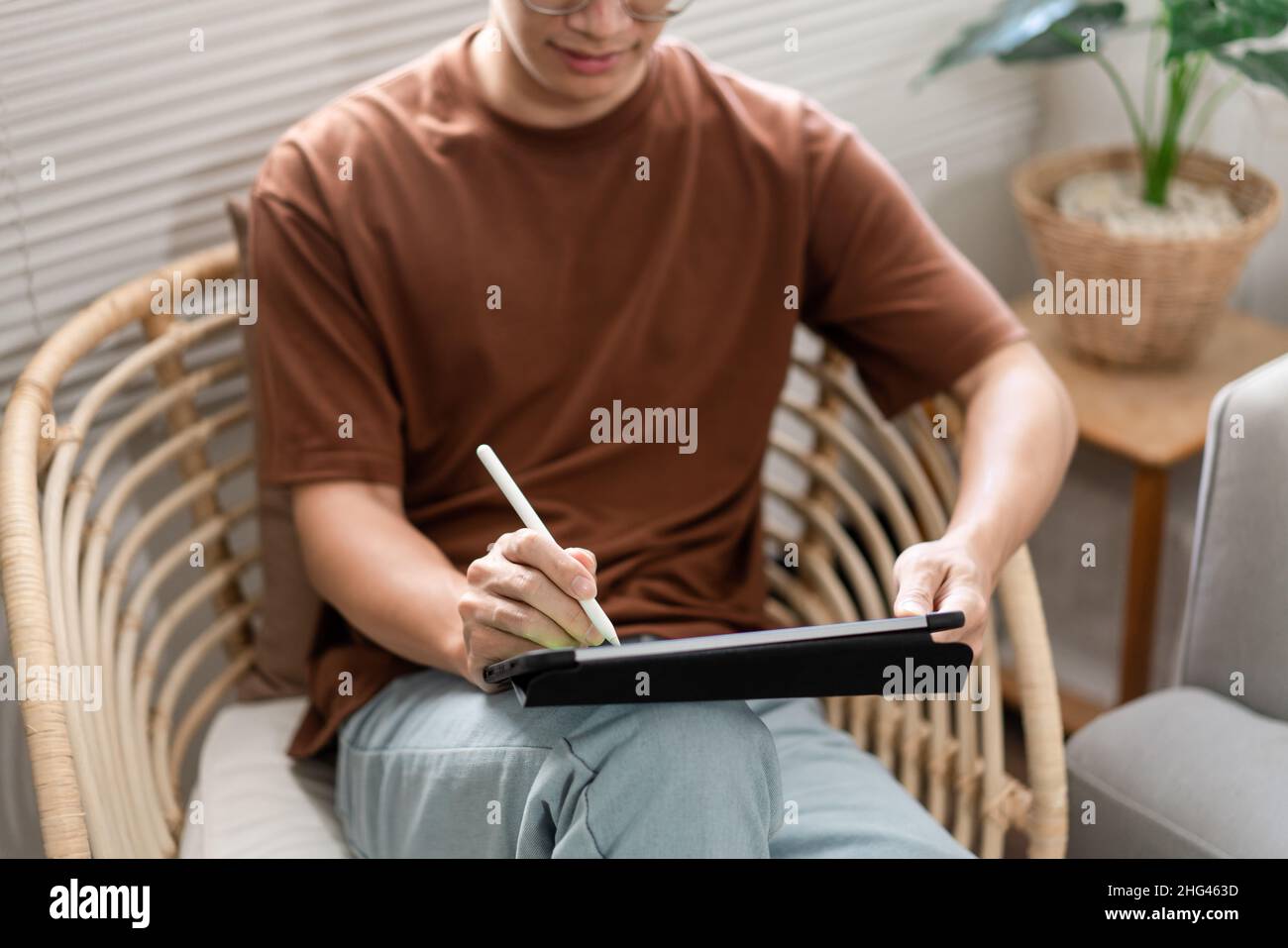 Technology Concept The young man who is sitting on the chair holding ...