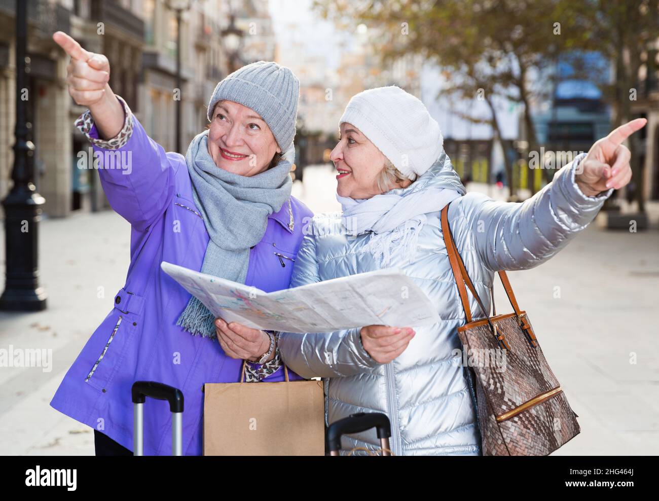 Elderly women tourists with city guide Stock Photo - Alamy