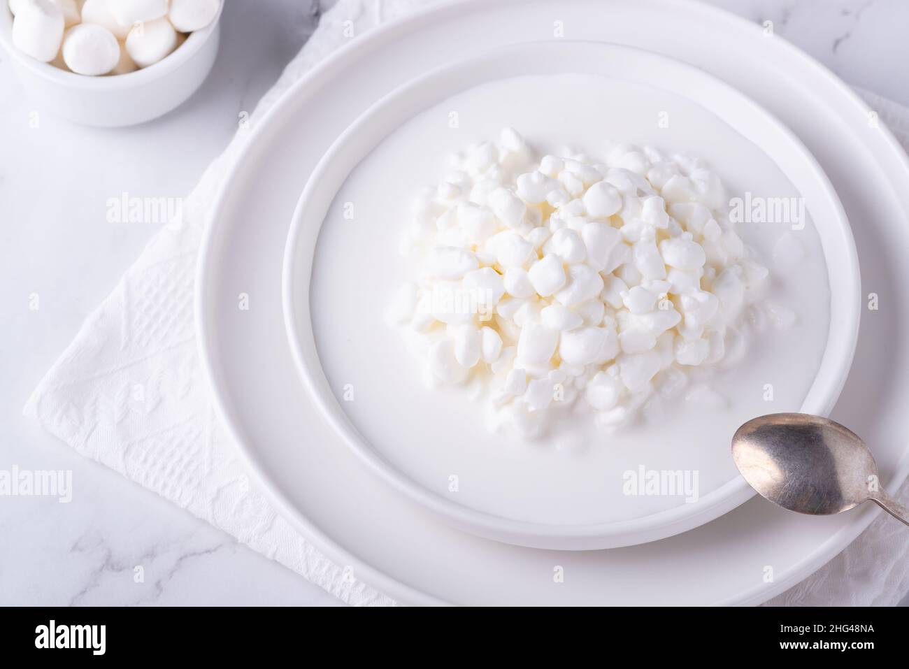 Fresh cottage cheese grain in a white bowl and marshmallows Stock Photo ...