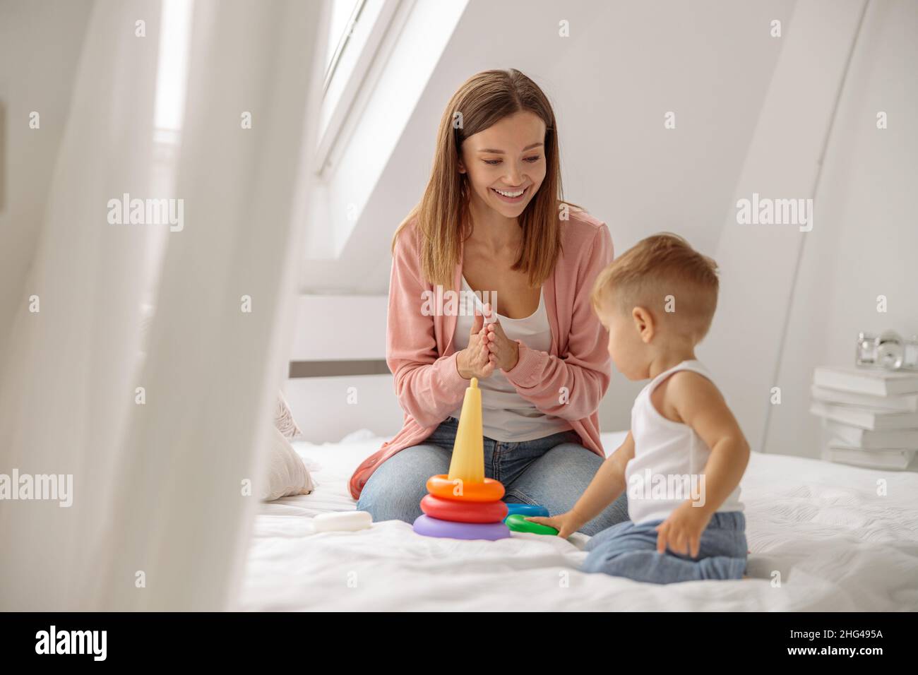Mom and little kid playing the colorful toy together Stock Photo - Alamy