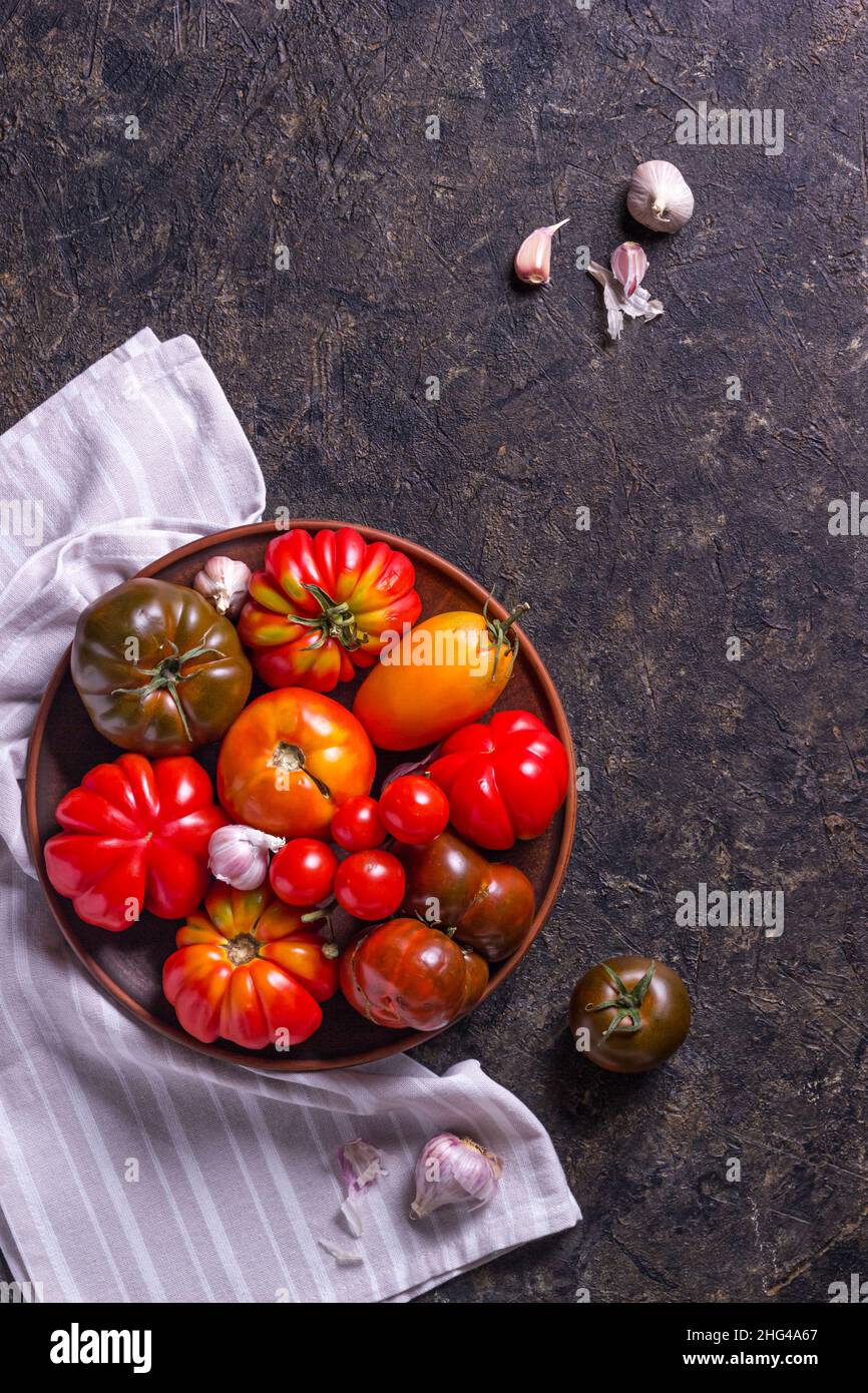 The harvest of assorted tomatoes. Colorful organic tomatoes on a large ...