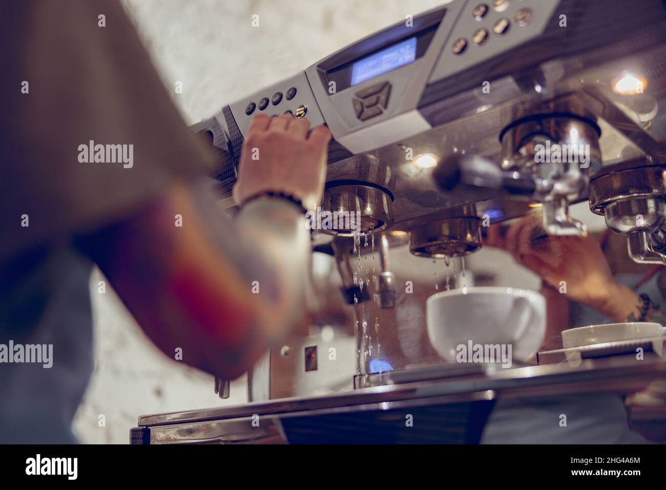 Young woman barista using coffee machine in cafeteria Stock Photo - Alamy