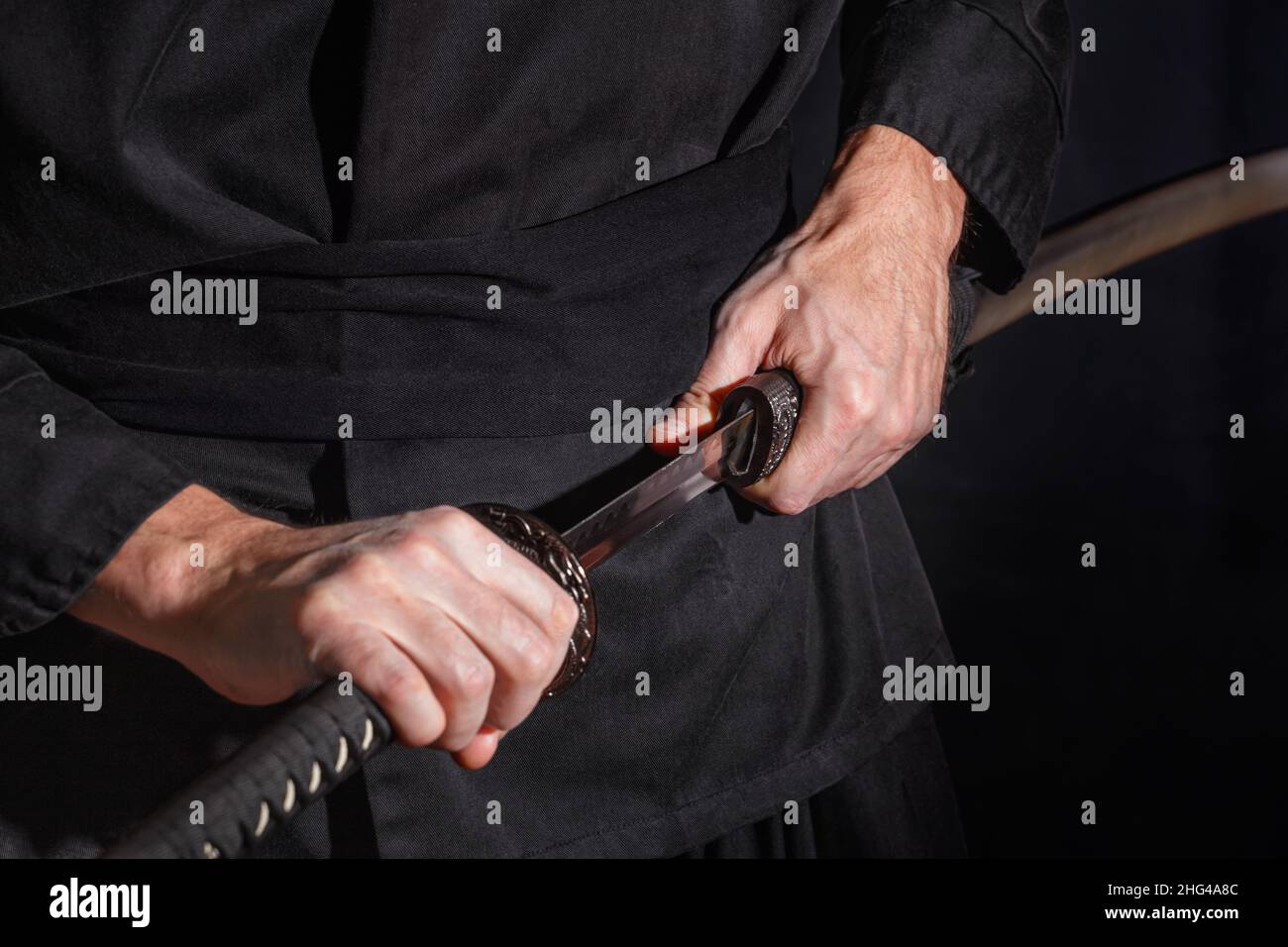 The samurai holding a Japanese katana sword. Photo of a warrior dressed ...