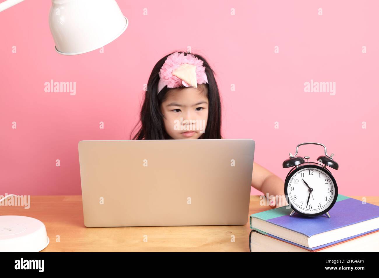 The cute Asian girl learning from internet by laptop with the pink ...