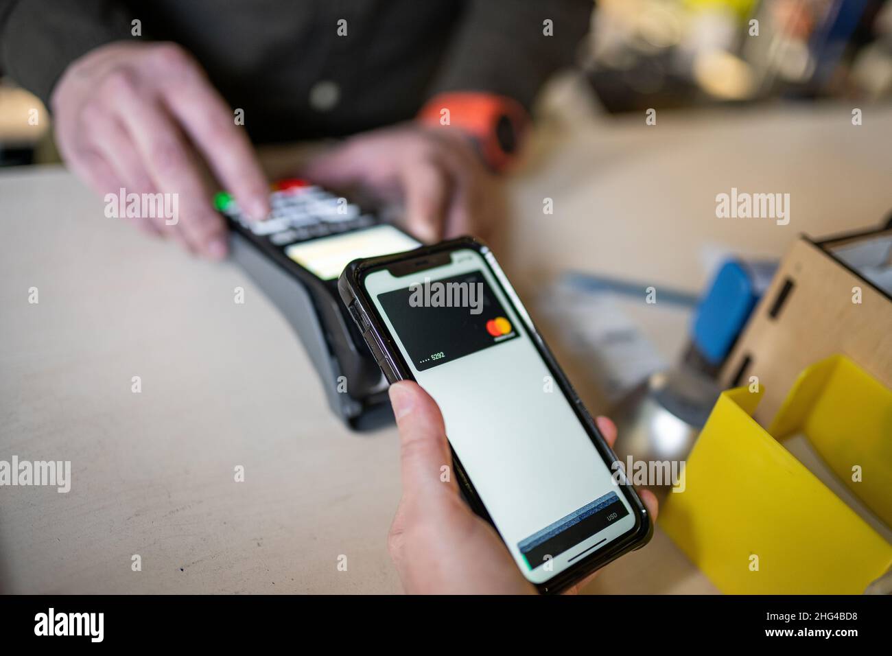 Shopping with mobile phone payment. Customer using contactless payment ...