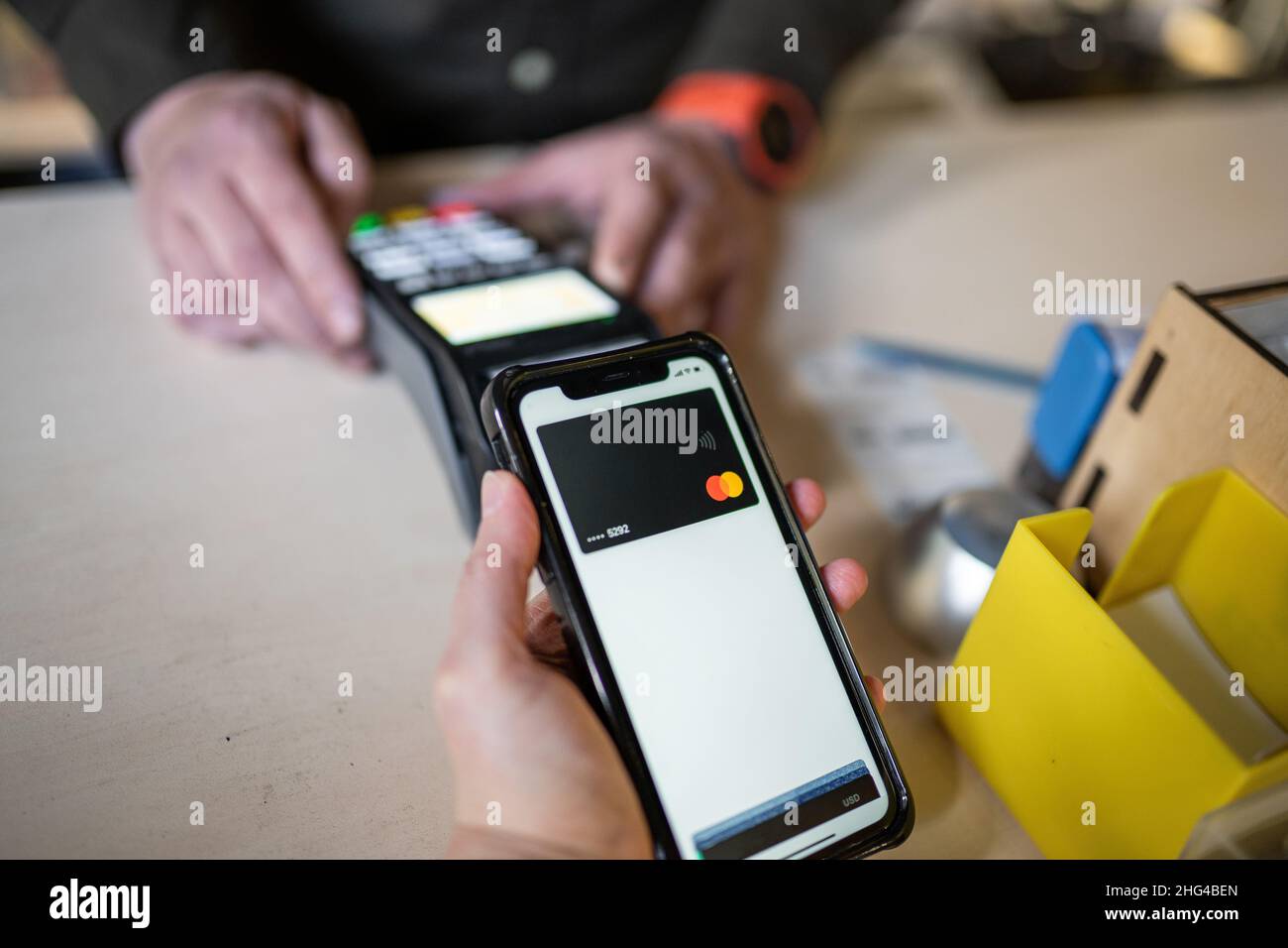 Close-up of woman making payment through NFC. Woman pays via payment ...