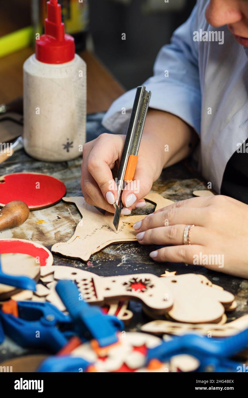 Closeup process making handmade wooden Christmas toys in carpentry ...