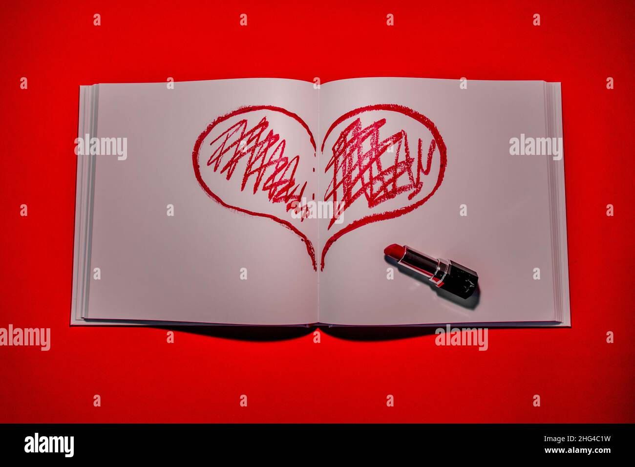 Drawn heart in a notebook on a red background. Happy Valentine's Day ...