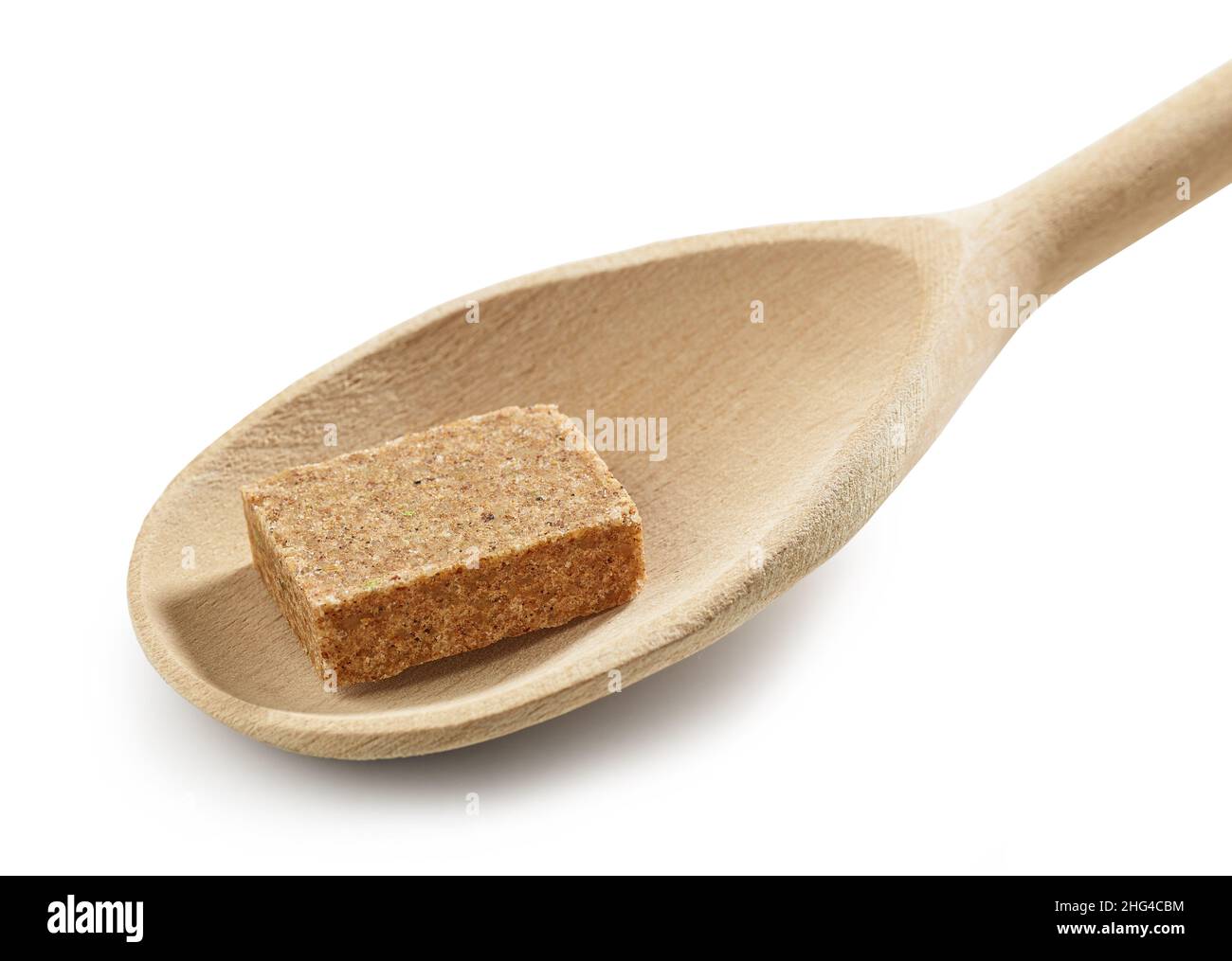instant beef broth cube in wooden spoon isolated on white background ...