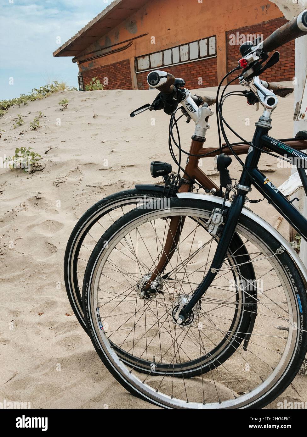 two sports bikes stand side by side on white sandy beach. Template free ...
