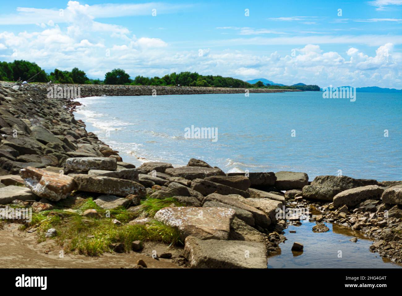 Blue sea under blue skies with white clouds at Tanjung Aru Beach, Kota ...