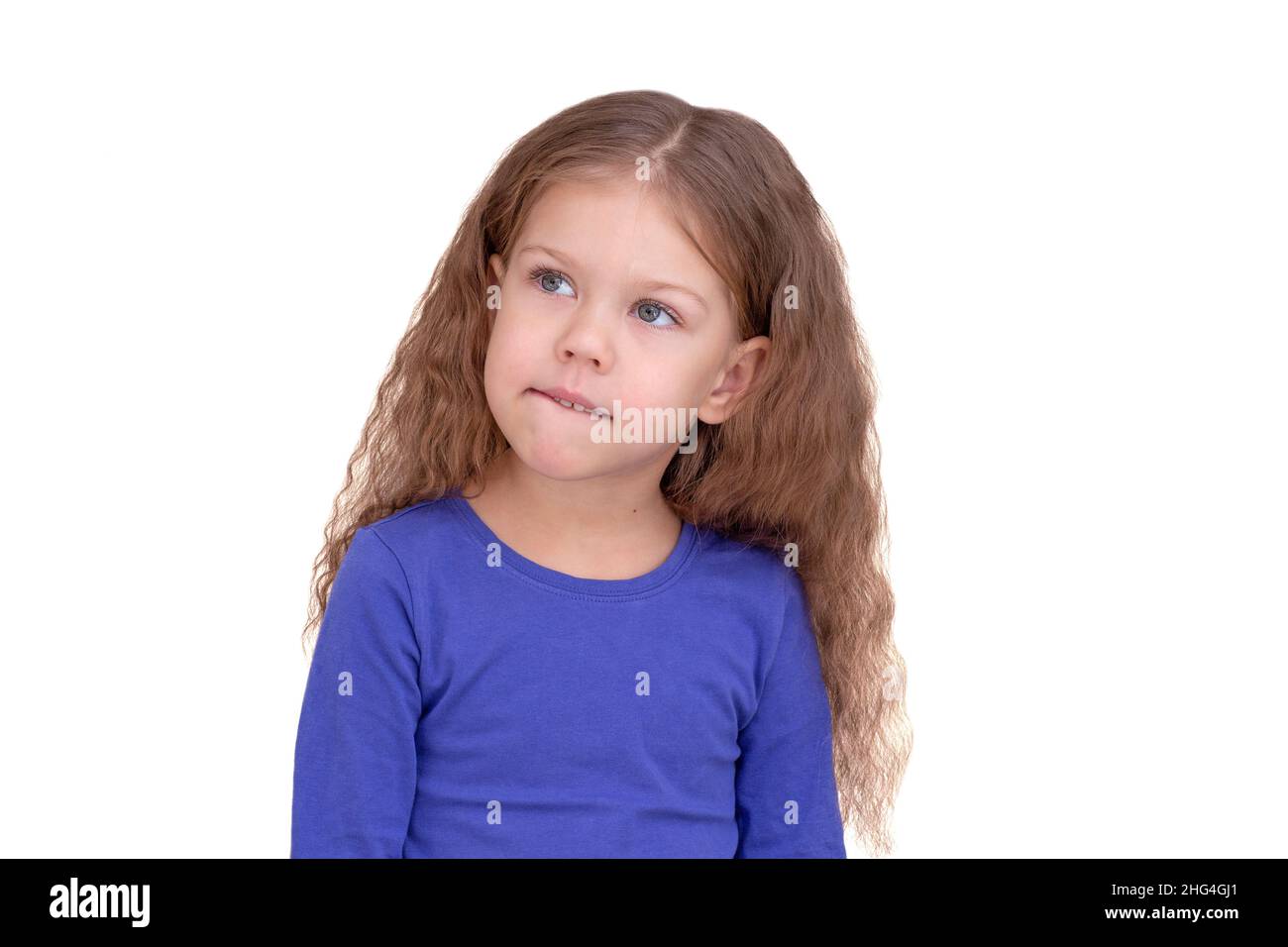 Serious and thinking child kid having a bite lower lip in planning ...