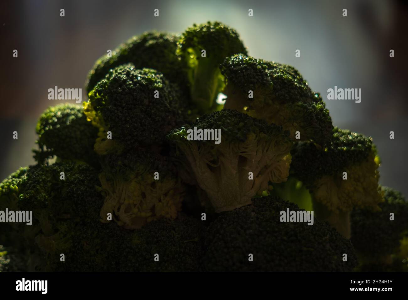 Frozen green broccoli florets on dark background closup Stock Photo - Alamy
