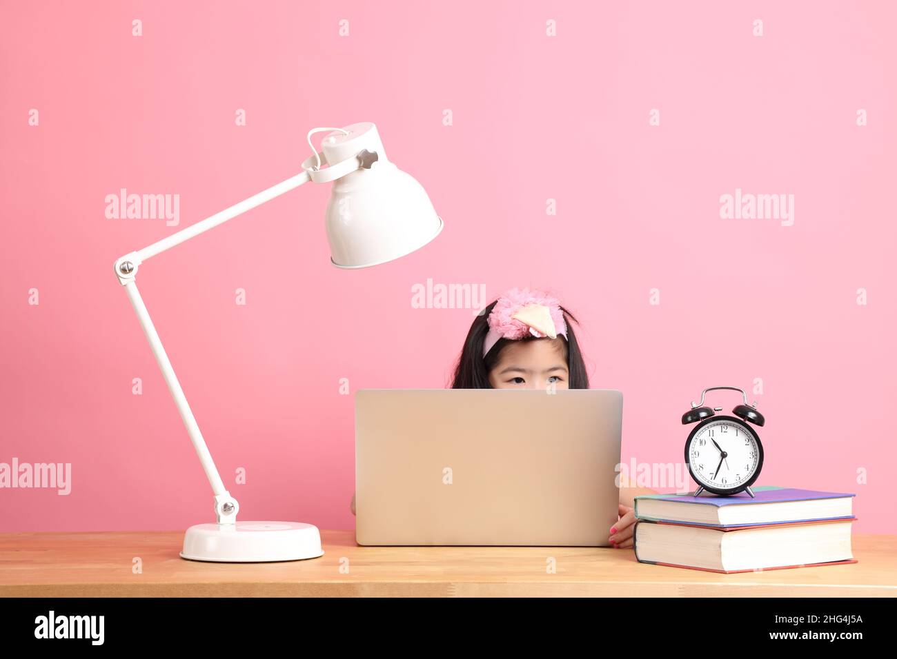 The cute Asian girl learning from internet by laptop with the pink ...