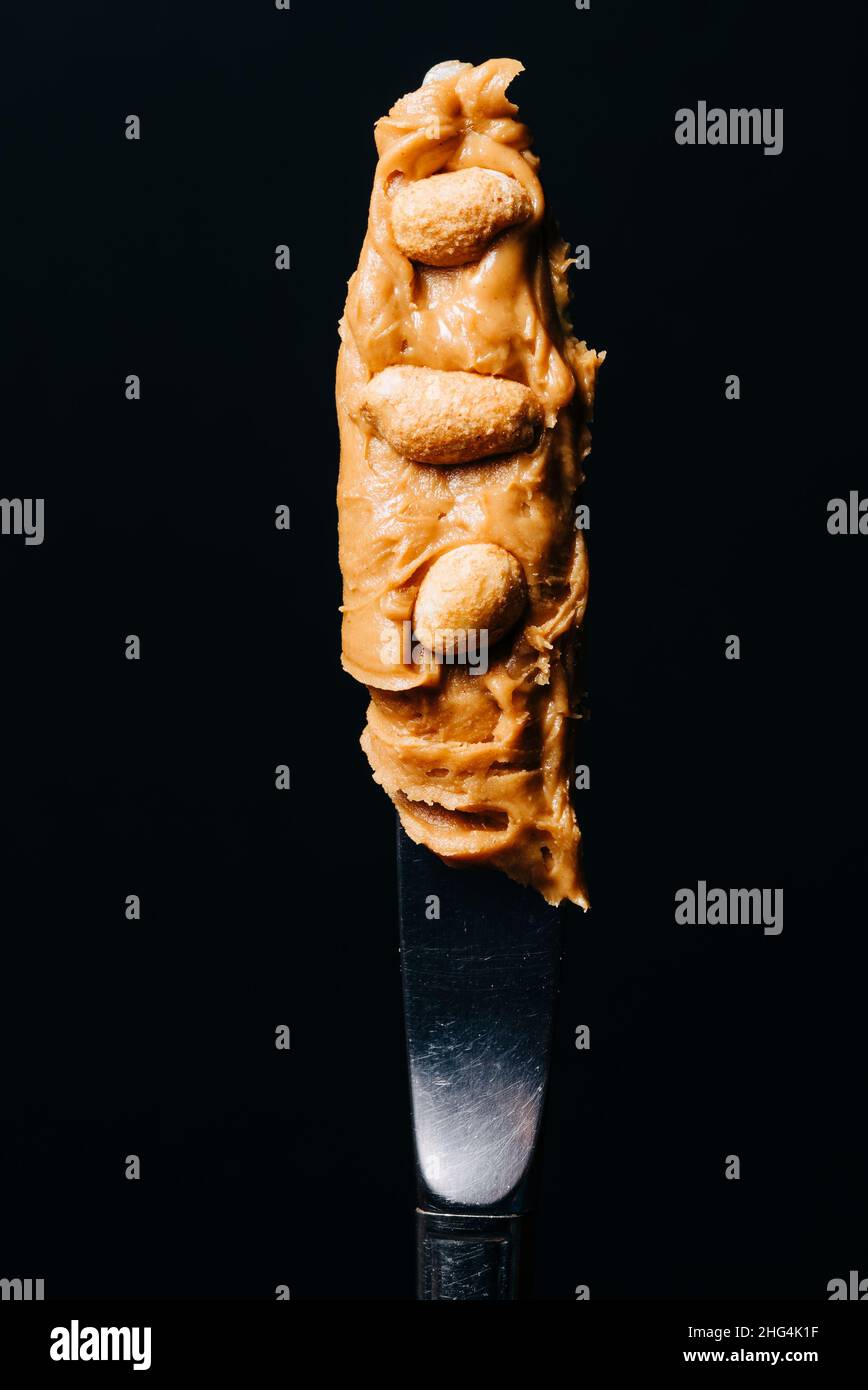 High contrast image of peanut butter on knife Stock Photo - Alamy