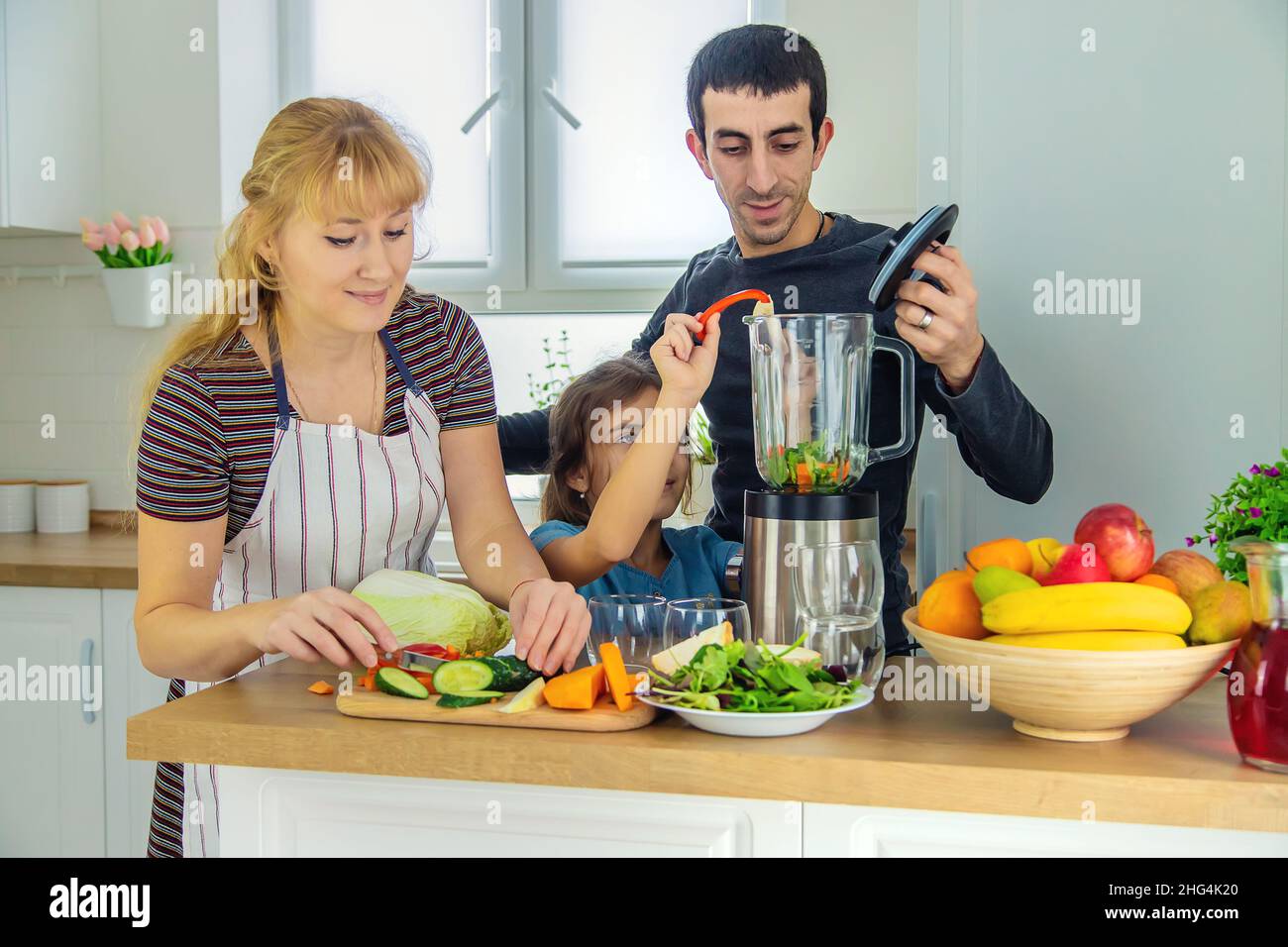 The family is making smoothies in the kitchen. Selective focus Stock ...