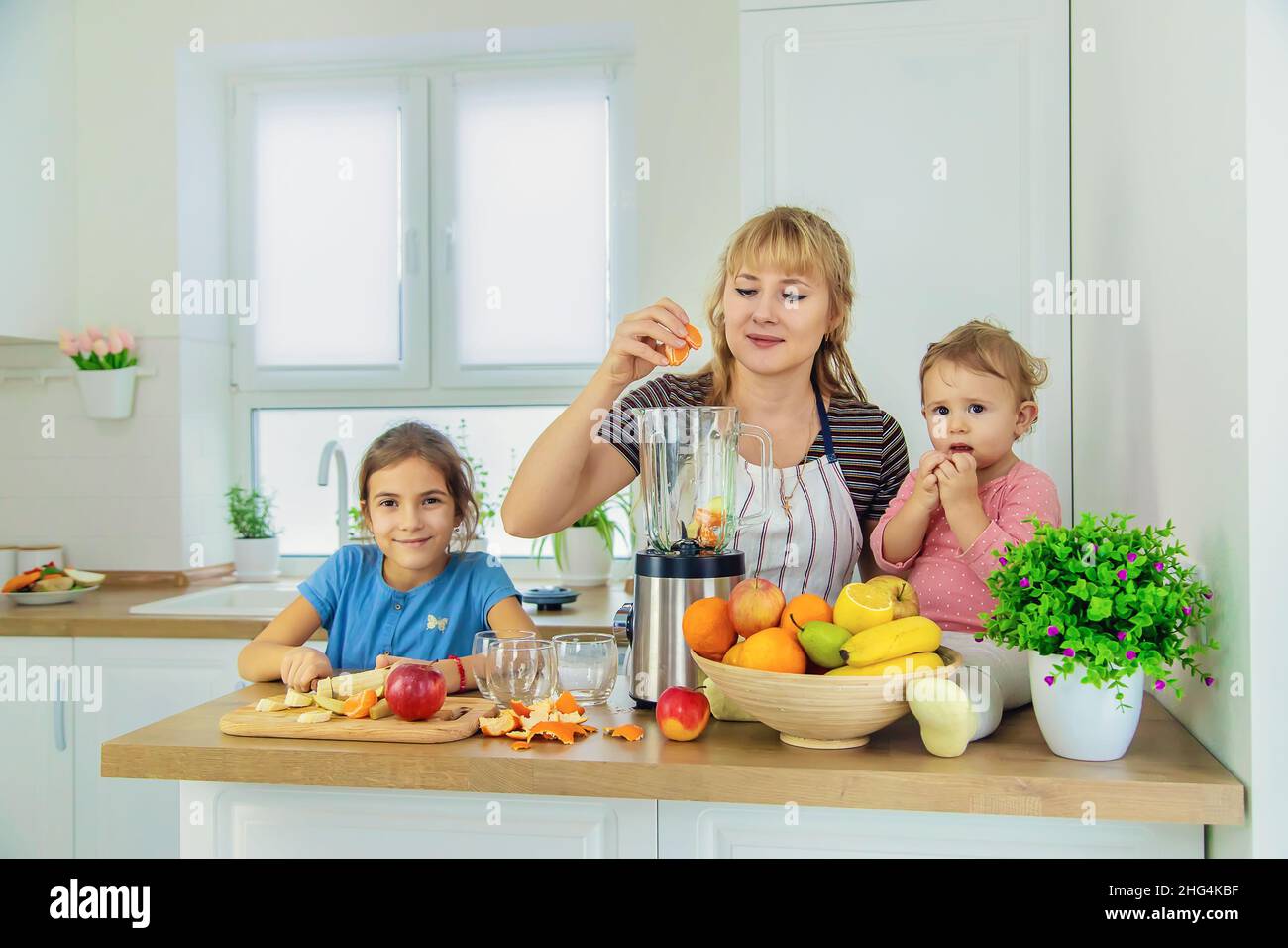 The family is making smoothies in the kitchen. Selective focus Stock ...