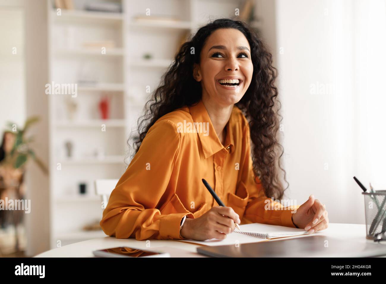 Happy Lady Taking Notes Sitting At Desk Holding Pen Indoor Stock Photo ...