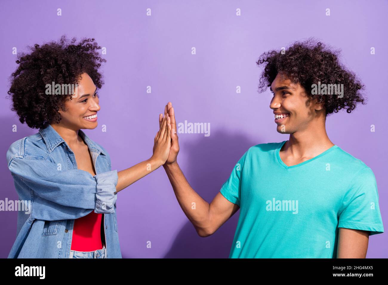 Photo of positive young happy afro american people give high-five ...