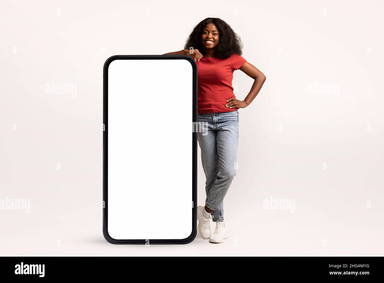 Mobile Offer. Cheerful Black Lady Leaning At Big Smartphone With Blank ...