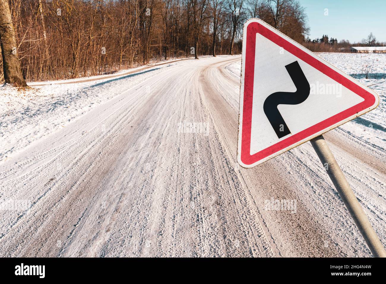 Double bend ahead right then left road sign in winter land. Warning on ...