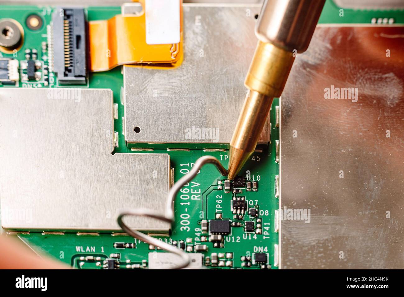 Bad electrical circuit being repaired by a technician with a tin ...