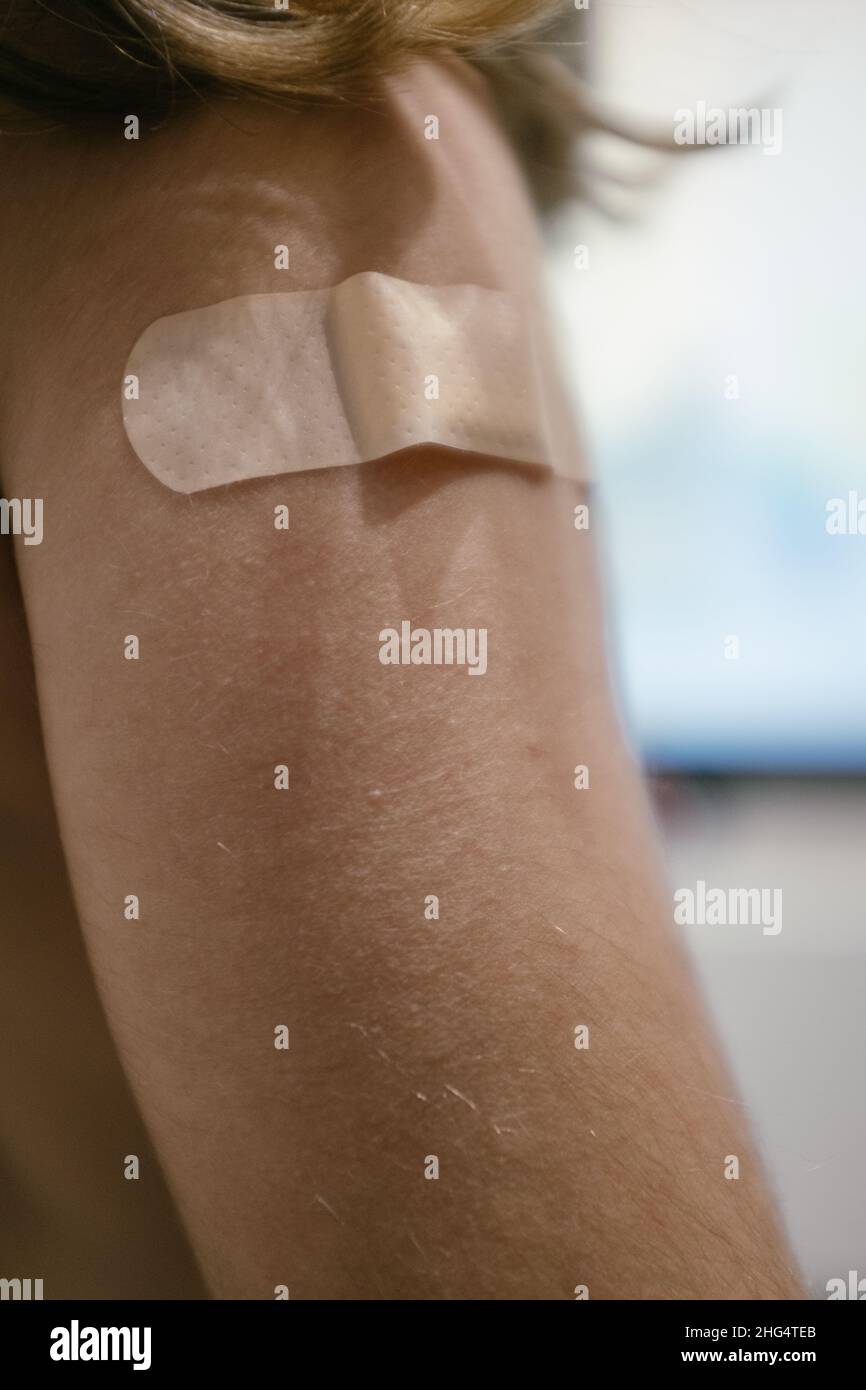 Band aid on a child shoulder after getting vaccinated Stock Photo - Alamy