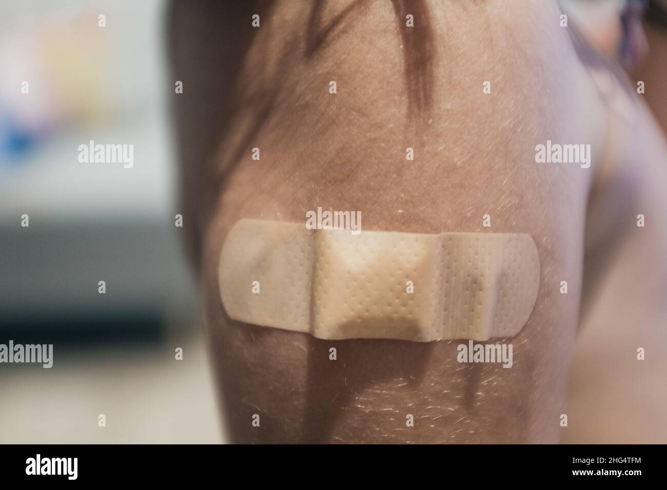 Band aid on a child shoulder after getting vaccinated Stock Photo - Alamy
