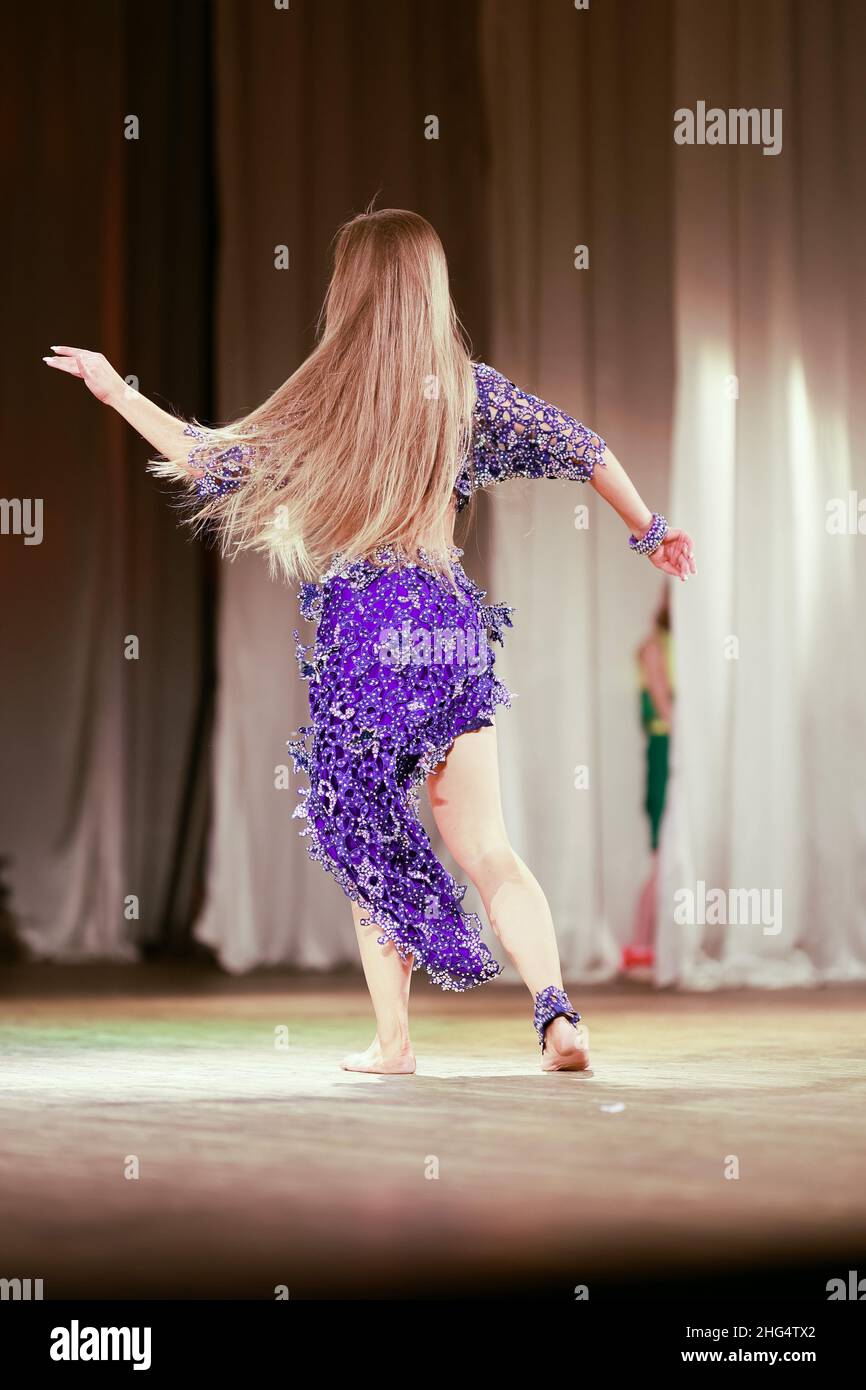 Girls dancers perform on stage with multi-colored lights. Backstage ...