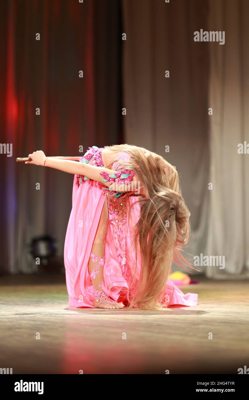 Girls dancers perform on stage with multi-colored lights. Backstage ...