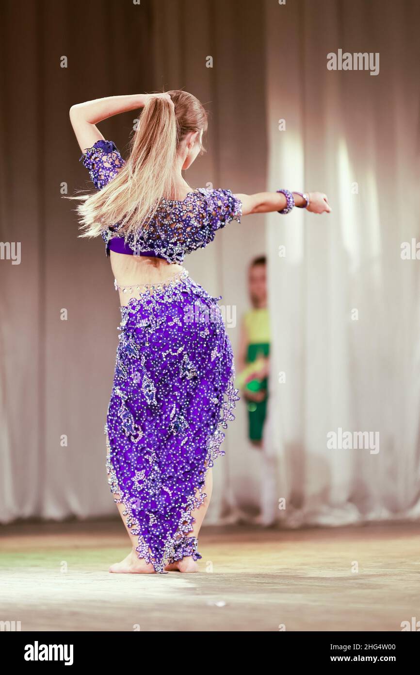 Girls dancers perform on stage with multi-colored lights. Backstage ...